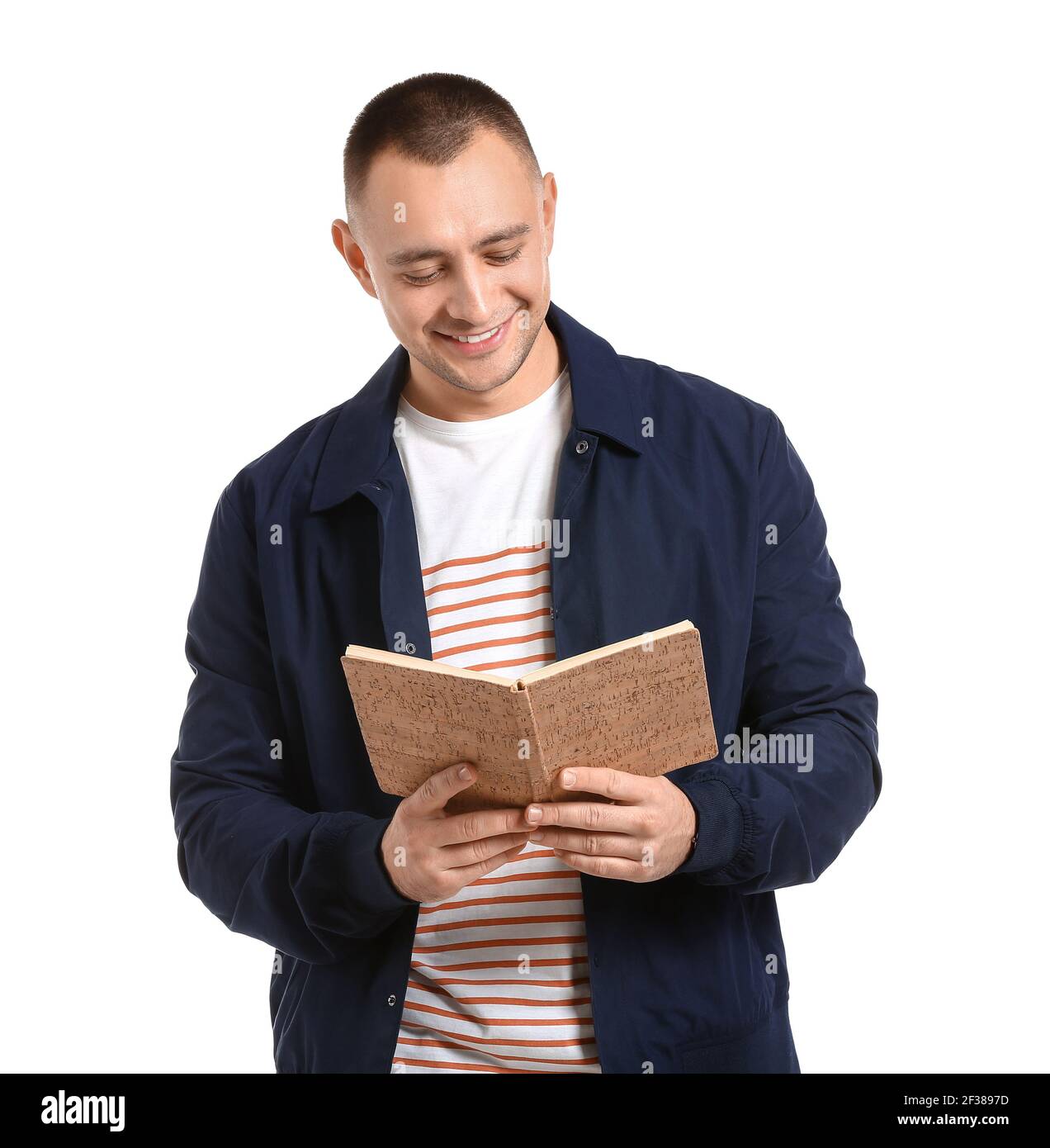 Handsome young man reading book on white background Stock Photo - Alamy