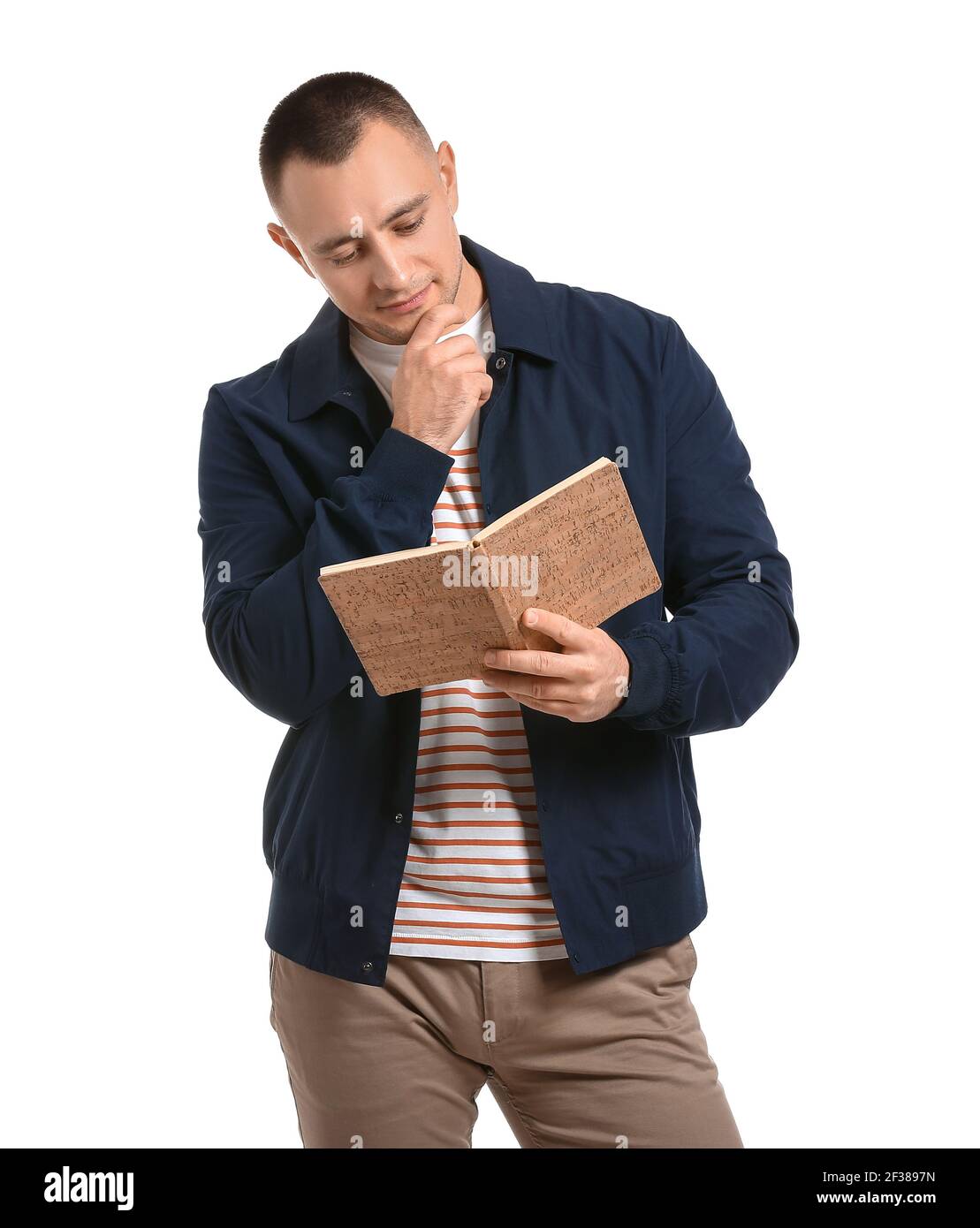 Handsome young man reading book on white background Stock Photo - Alamy