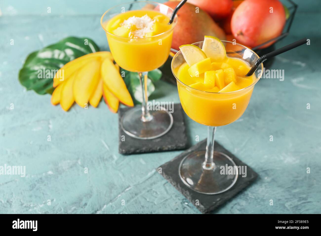 Glasses of mango margarita on color background Stock Photo - Alamy