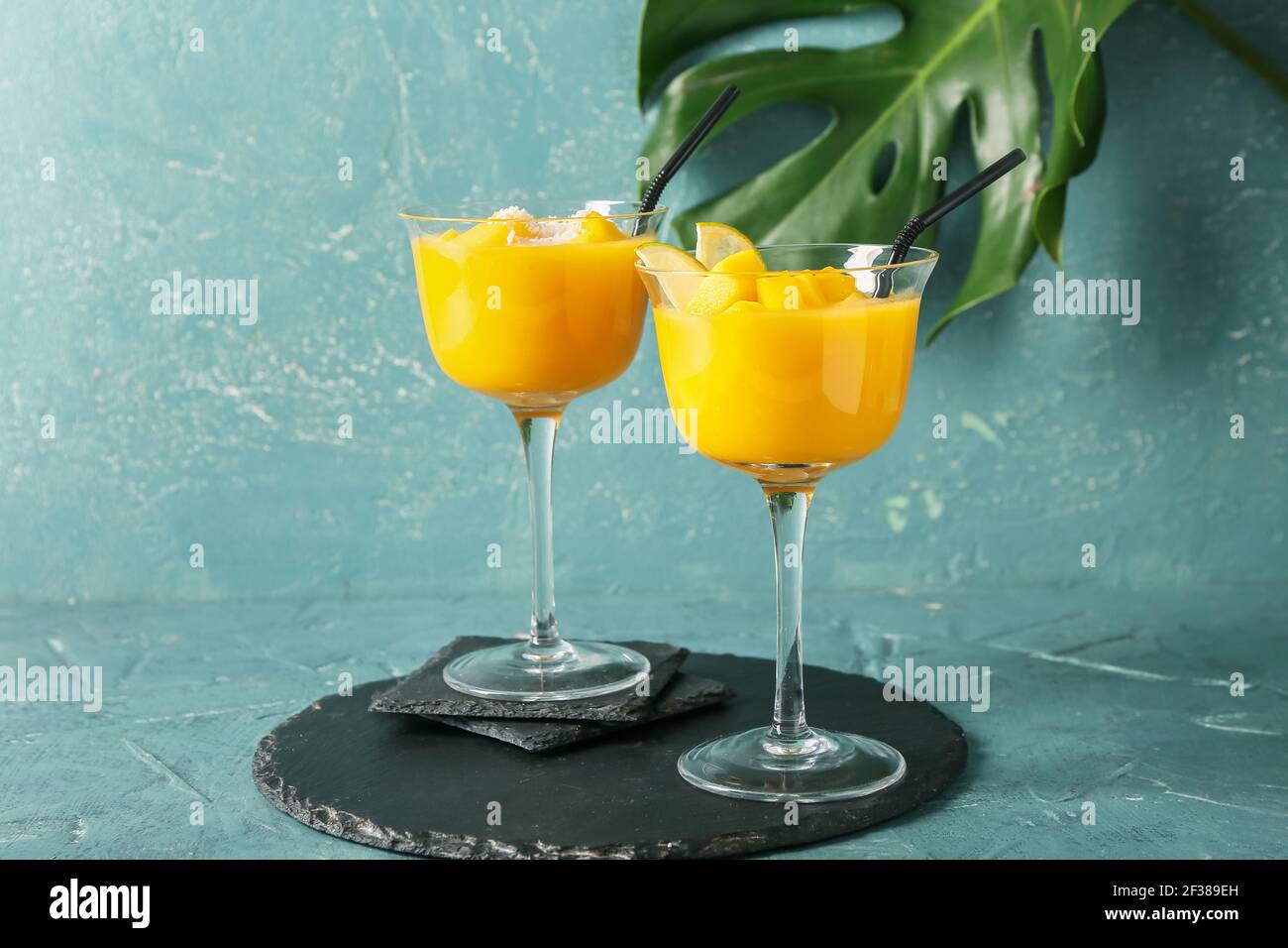 Glasses of mango margarita on color background Stock Photo - Alamy