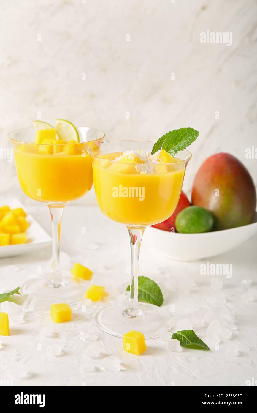Glasses of mango margarita on light background Stock Photo - Alamy