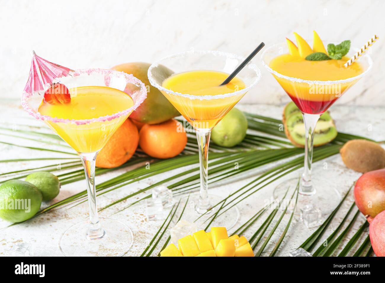 Glasses of mango margarita on light background Stock Photo - Alamy