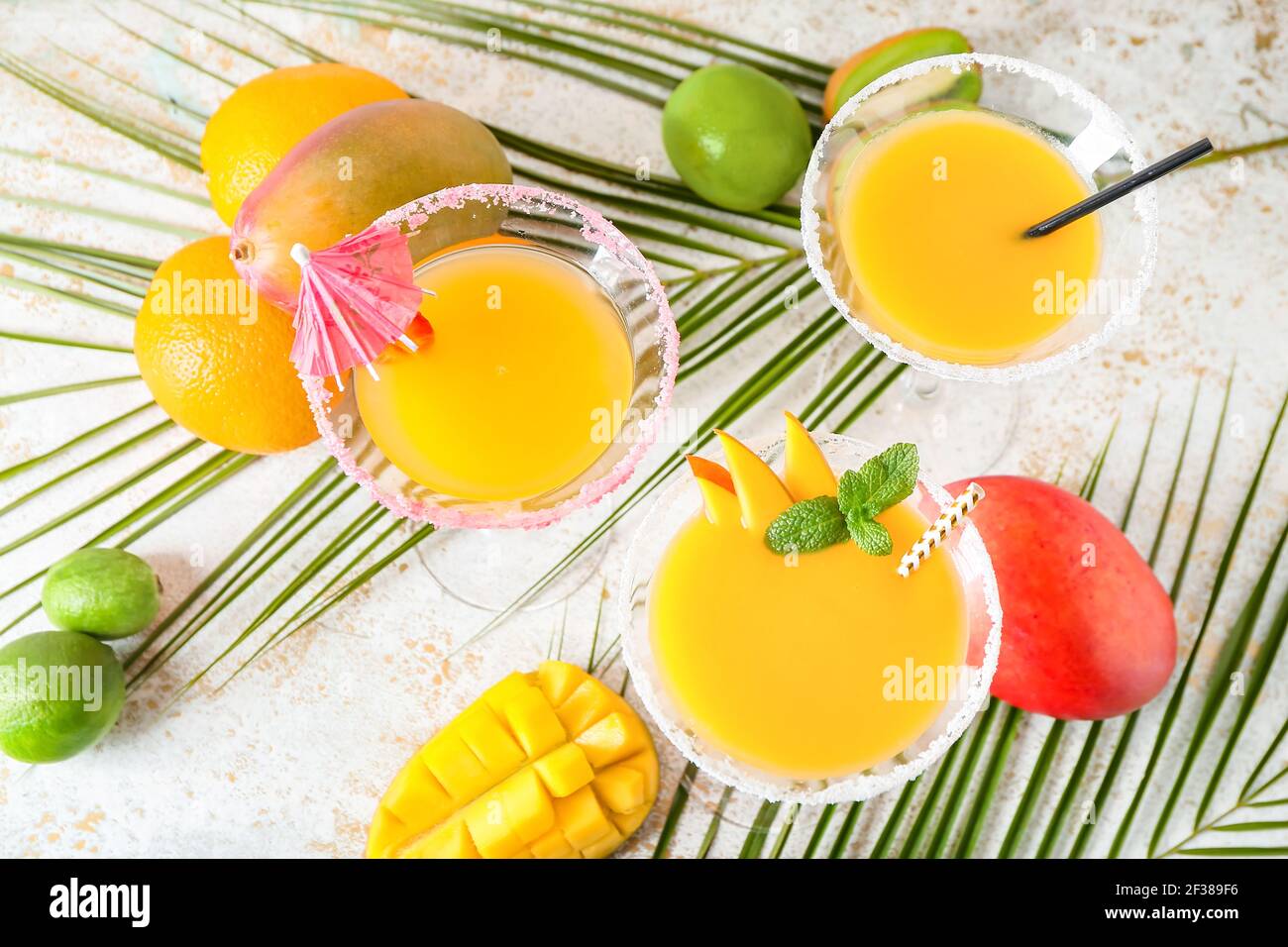 Glasses of mango margarita on light background Stock Photo - Alamy
