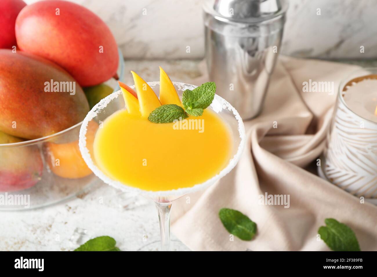 Glass of mango margarita on light background Stock Photo - Alamy