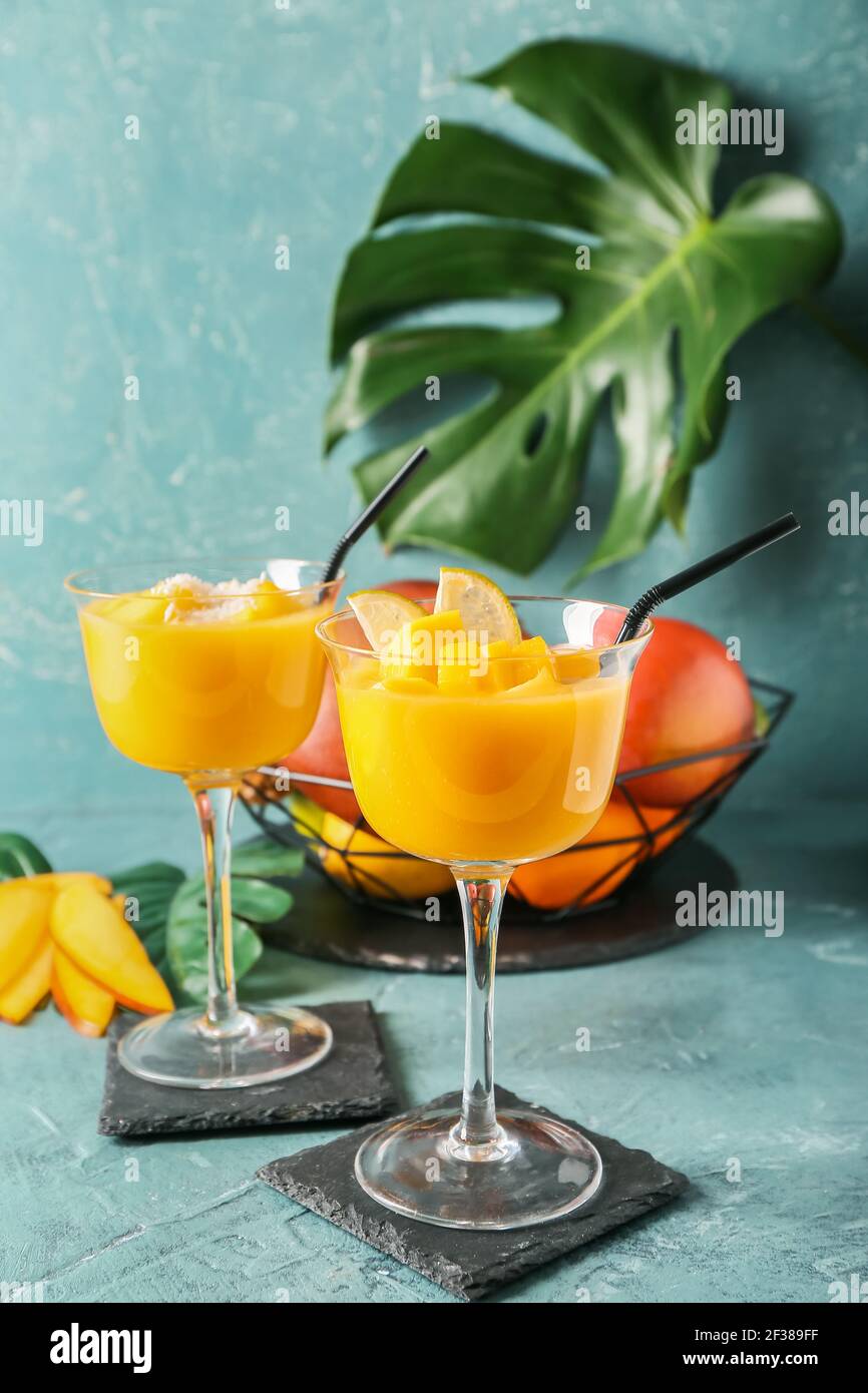 Glasses of mango margarita on color background Stock Photo - Alamy