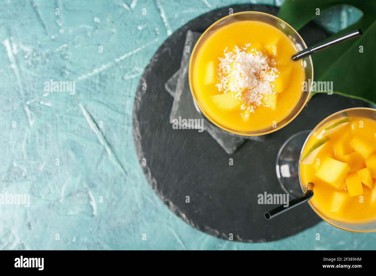 Glasses of mango margarita on color background Stock Photo - Alamy
