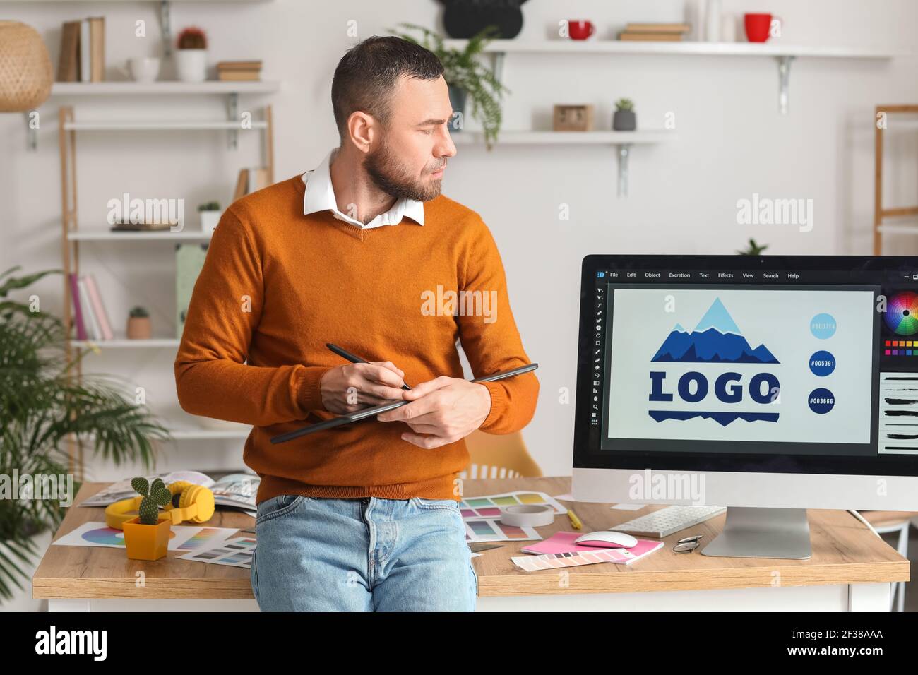 Male designer working in office Stock Photo - Alamy