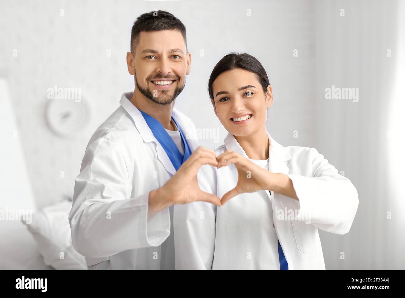 Cardiologists making heart with their hands in clinic Stock Photo - Alamy