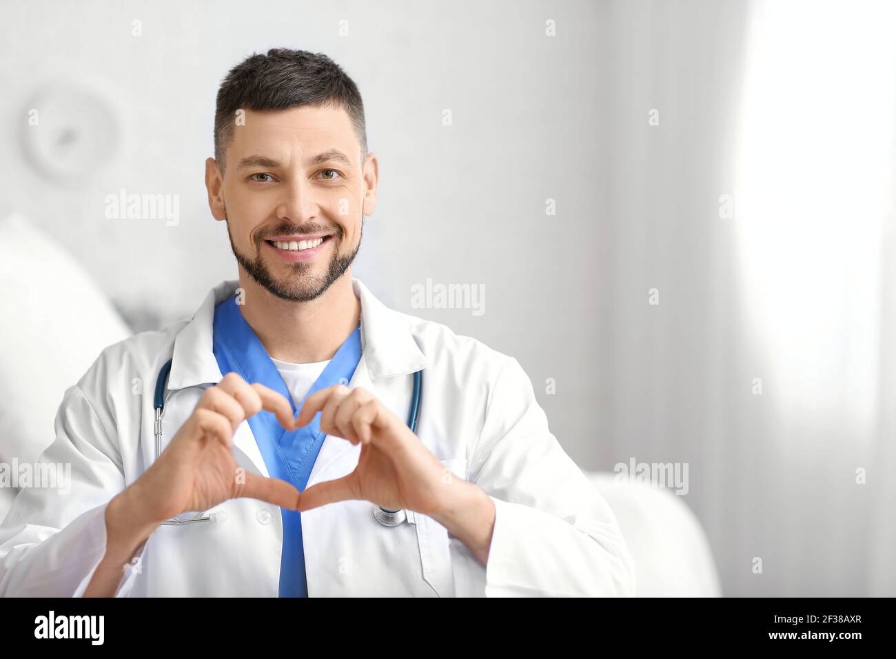 Cardiologist making heart with his hands in clinic Stock Photo - Alamy