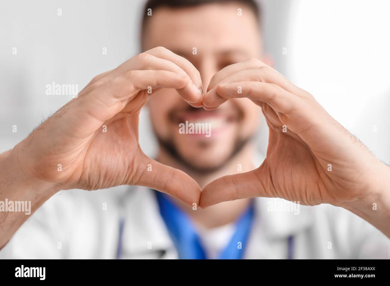 Cardiologist making heart with his hands in clinic Stock Photo - Alamy