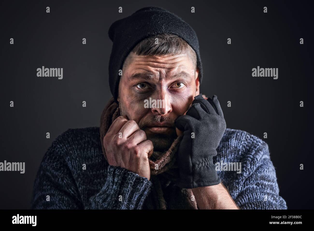 Portrait of poor homeless man on dark background Stock Photo - Alamy