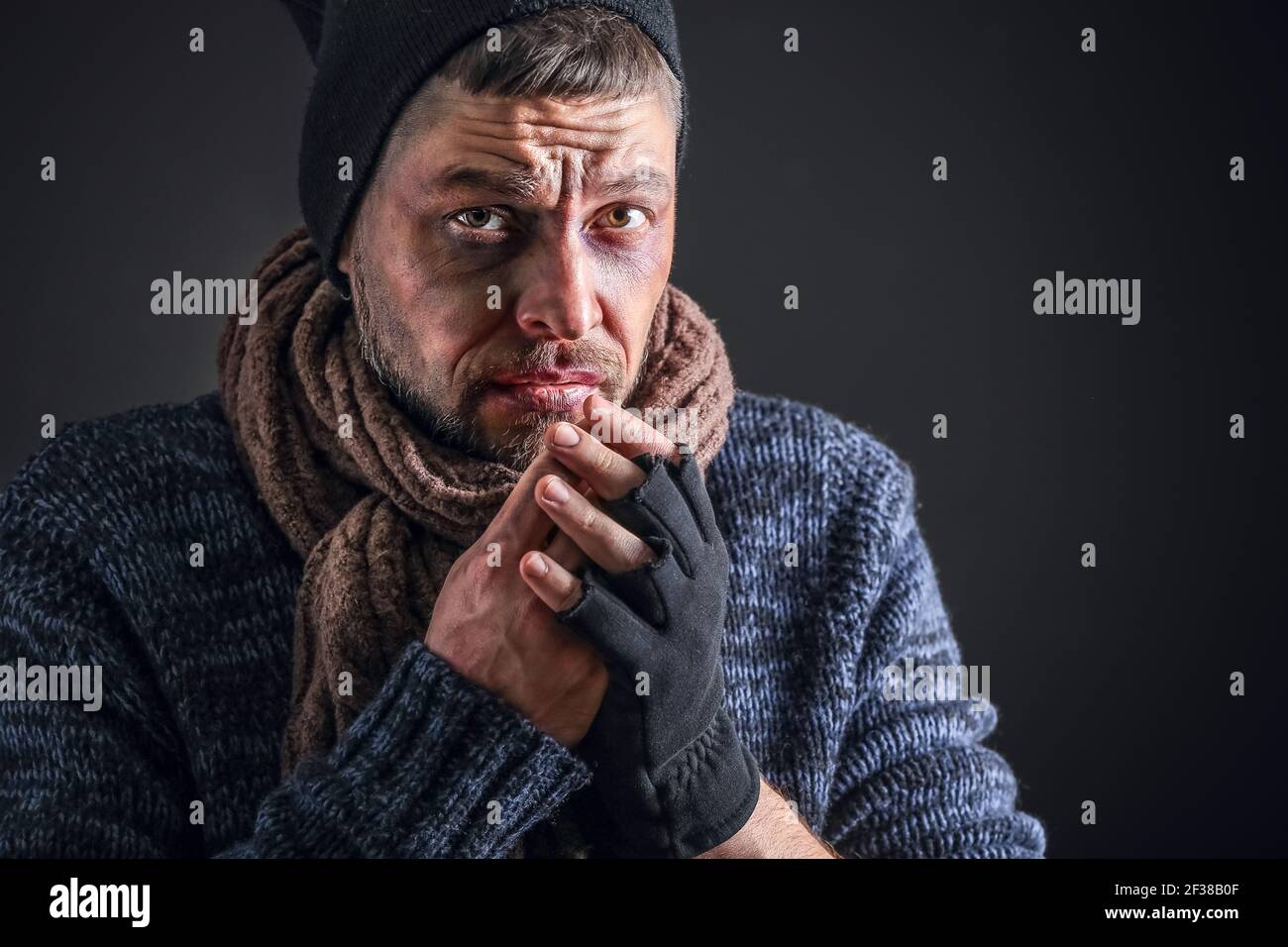 Portrait of poor homeless man on dark background Stock Photo - Alamy