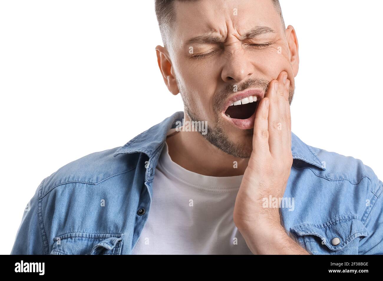 Man suffering from tooth ache on white background Stock Photo - Alamy