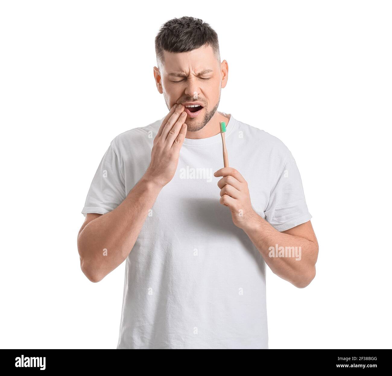 Man with aching teeth and tooth brush on white background Stock Photo ...