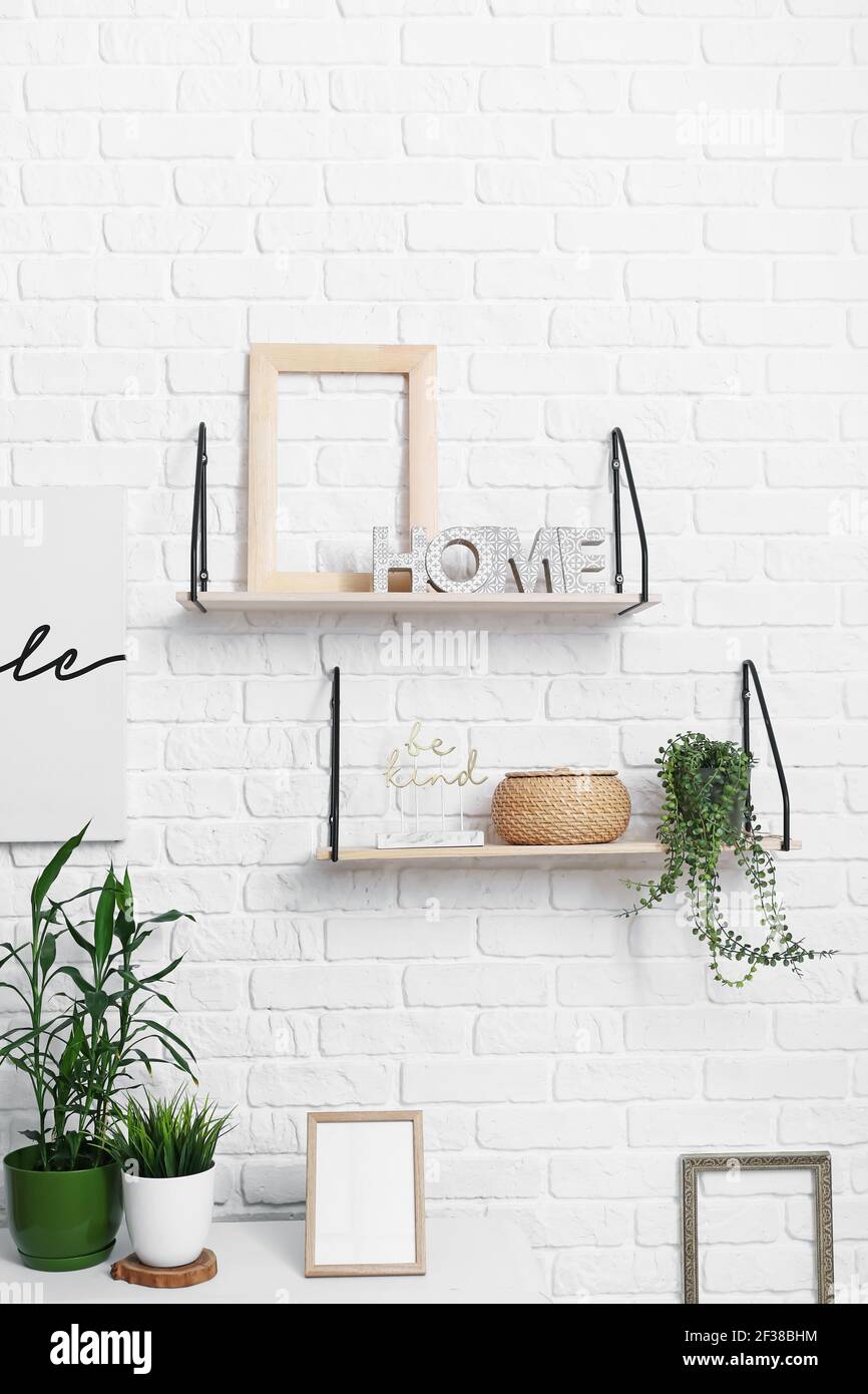 Hanging shelves on brick wall hi-res stock photography and images - Alamy