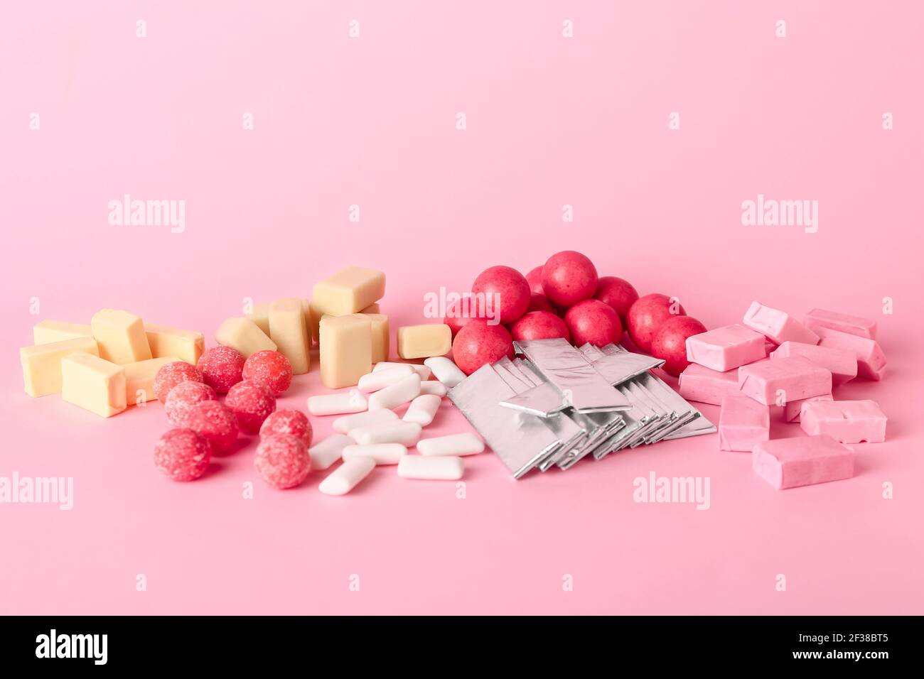 Tasty chewing gums on color background Stock Photo - Alamy
