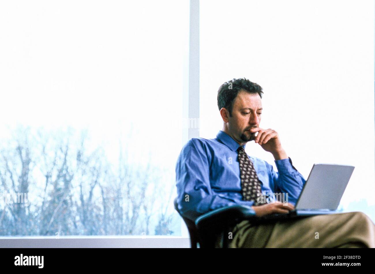 Businessman working on laptop Stock Photo - Alamy