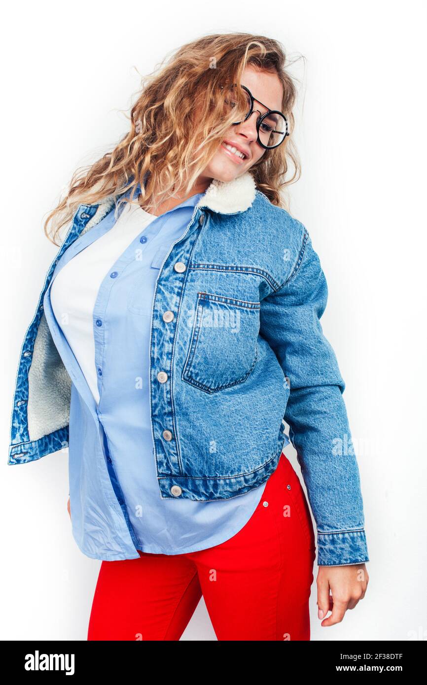 young pretty blond teenage hipster girl in glasses posing emotional ...