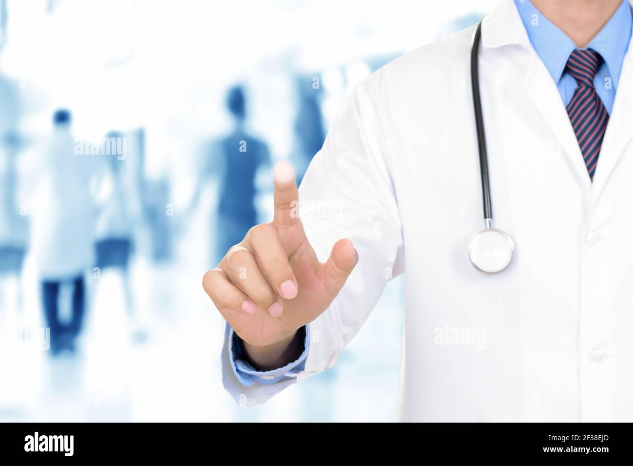 Doctor hand touching empty virtual screen on blur hospital background ...