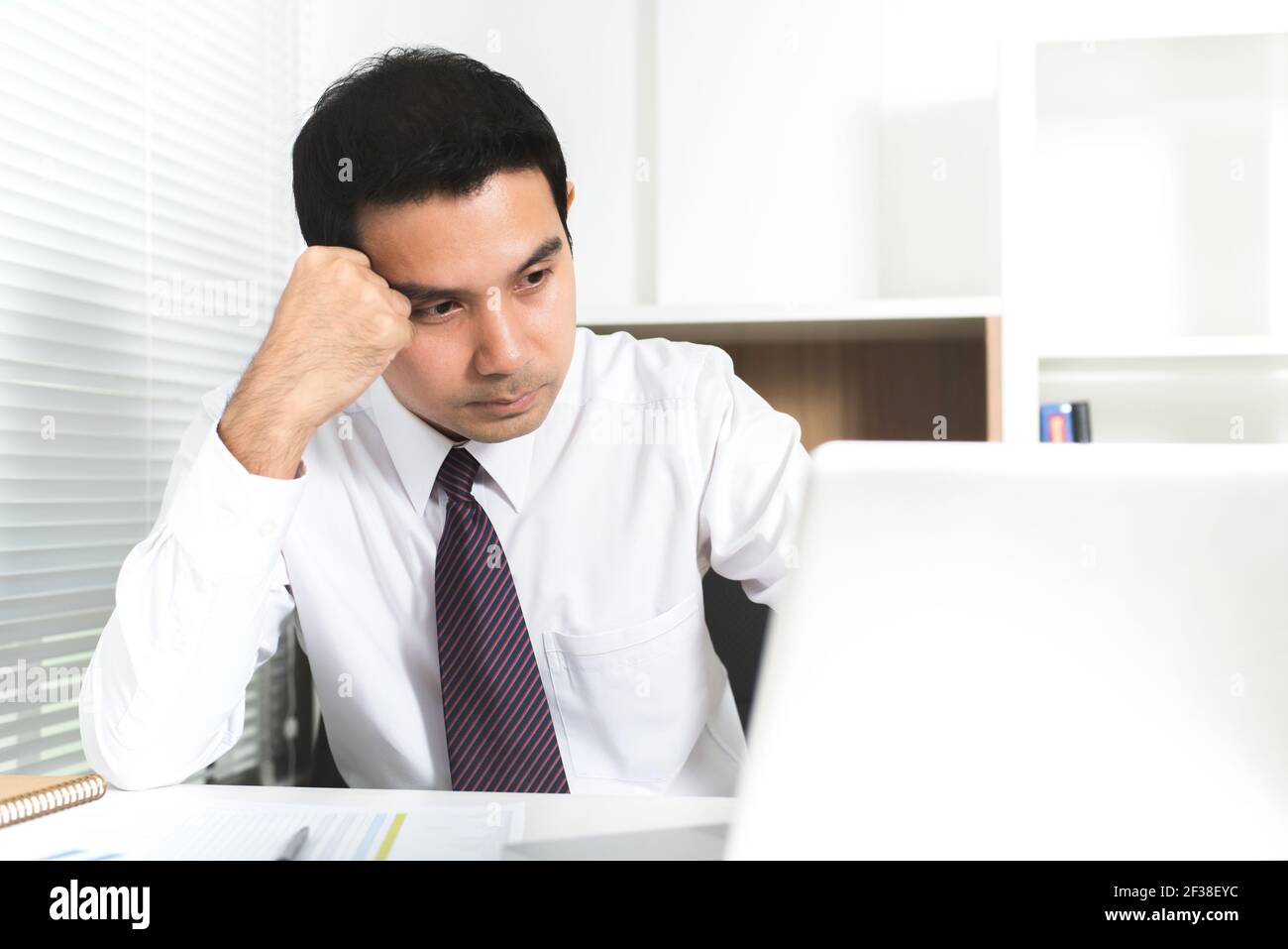 Asian businessman getting stressed (upset) at work Stock Photo - Alamy