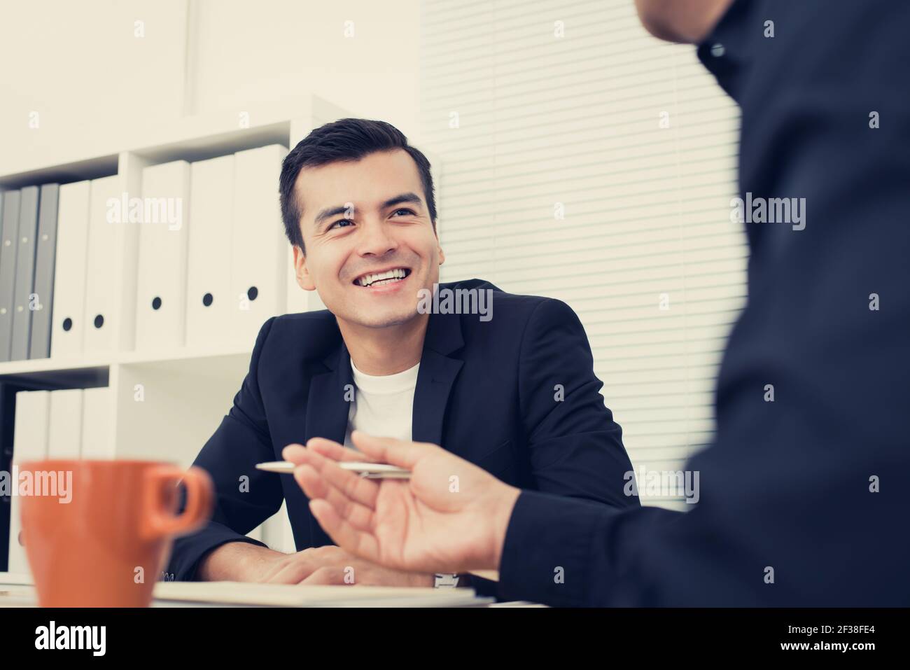 Young hispanic man sitting smiling hi-res stock photography and images ...