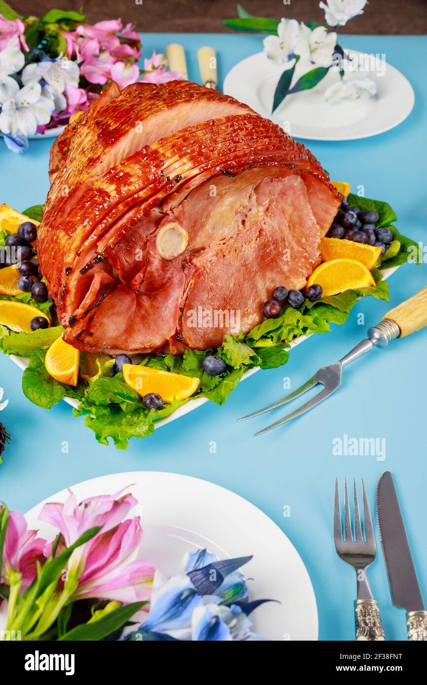 Spiral sliced glazed ham on festive table for Easter Stock Photo - Alamy