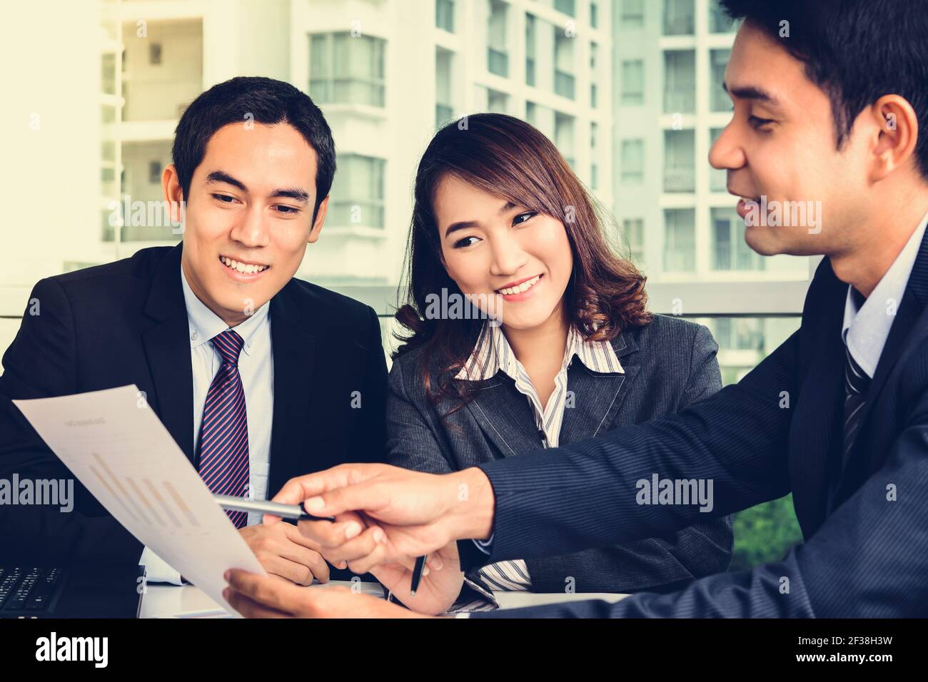 Business people discussing document in the meeting Stock Photo - Alamy