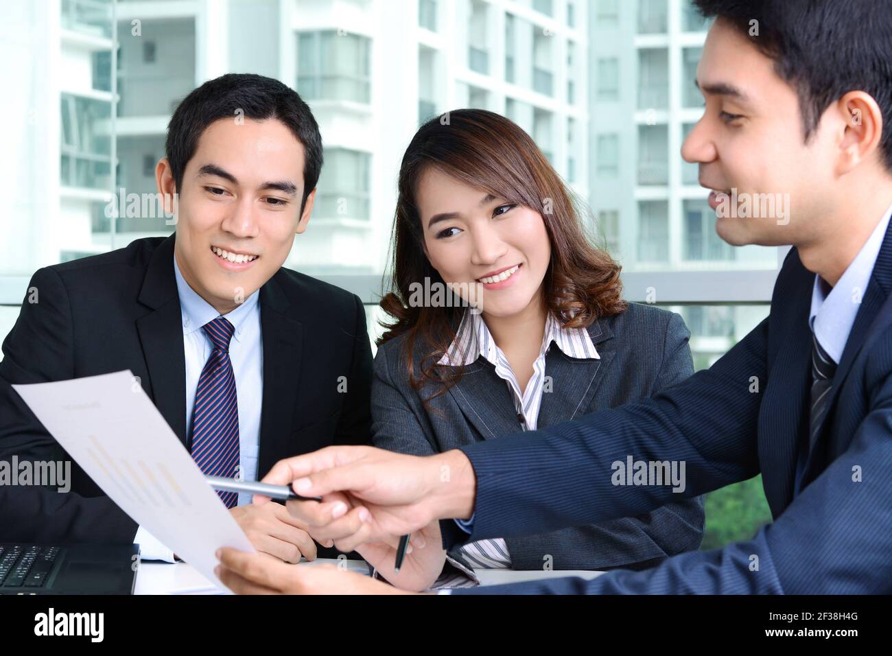 Asian business people discussing document in the meeting Stock Photo ...