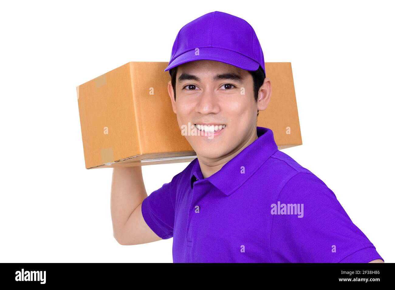 Smiling young delivery man carrying parcel box on white background ...