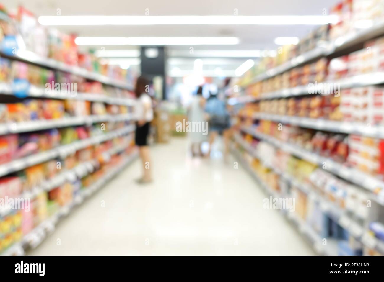 Blur image of aisle in supermarket with customers - for background ...