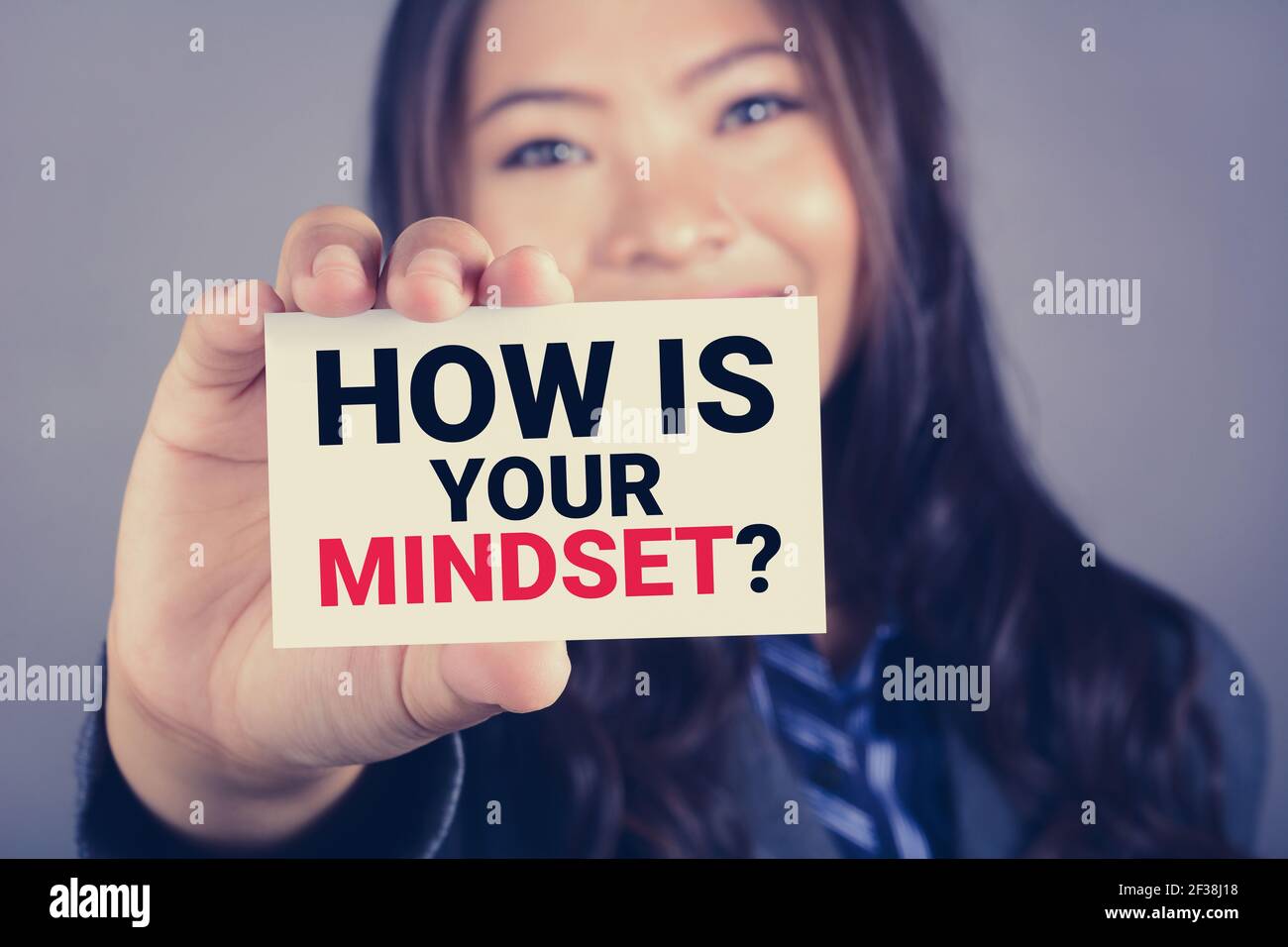 HOW IS YOUR MINDSET? message on the card shown by a woman, vintage tone ...