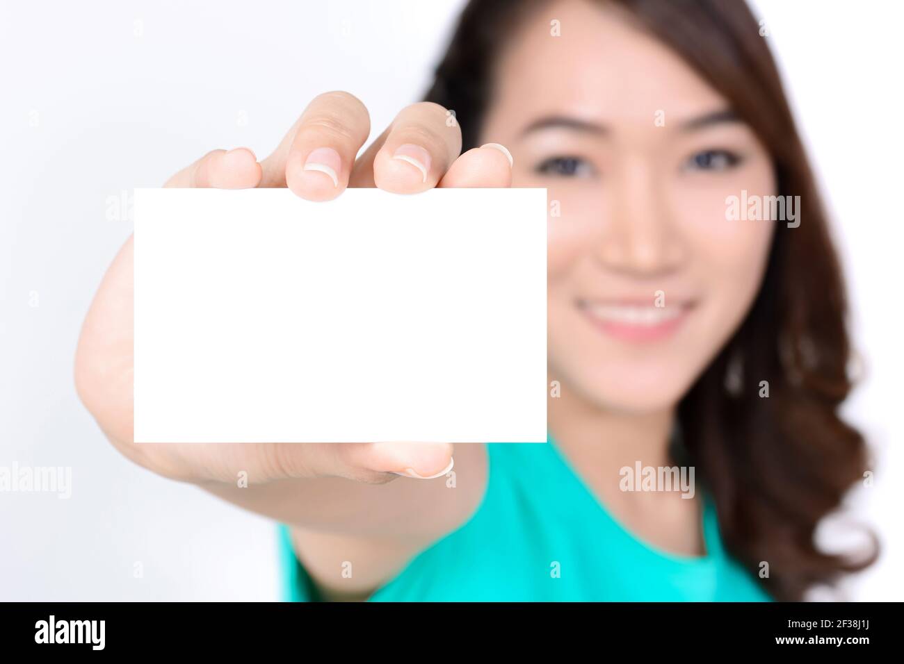 Empty white card shown by smiling young woman Stock Photo - Alamy