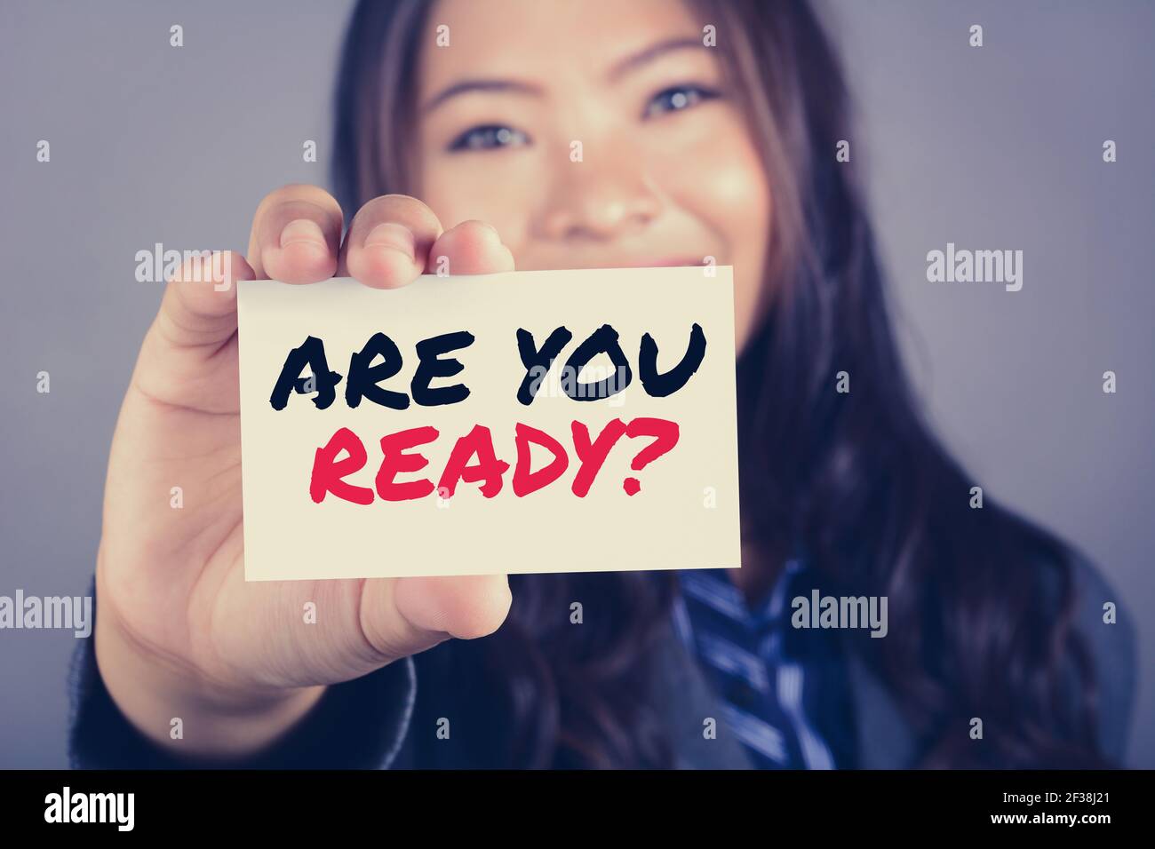 ARE YOU READY? message on the card shown by a woman, vintage tone Stock ...
