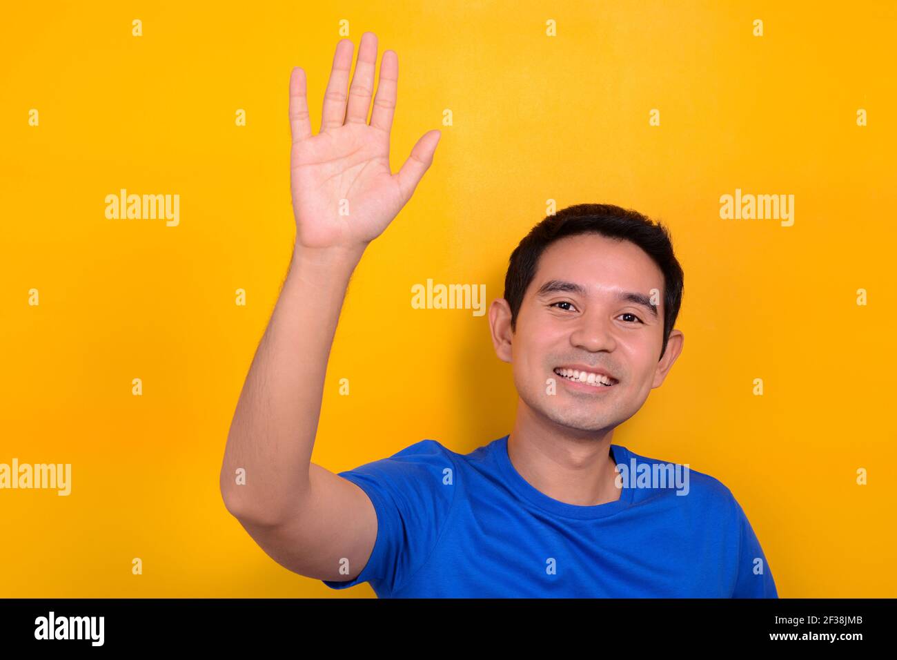 Smiling Asian man giving high five Stock Photo - Alamy