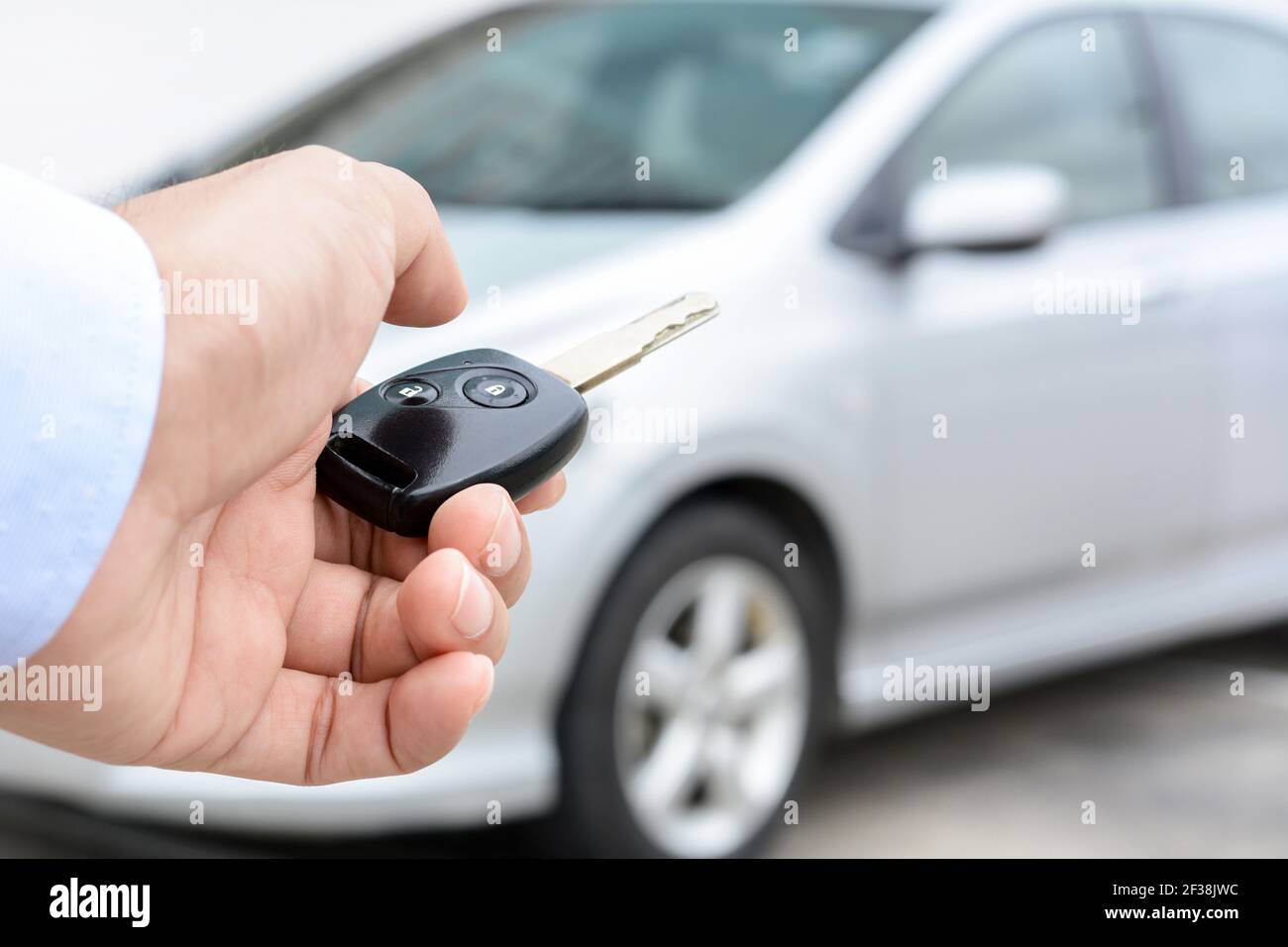 A man hand about to press button of remote control car key Stock Photo ...