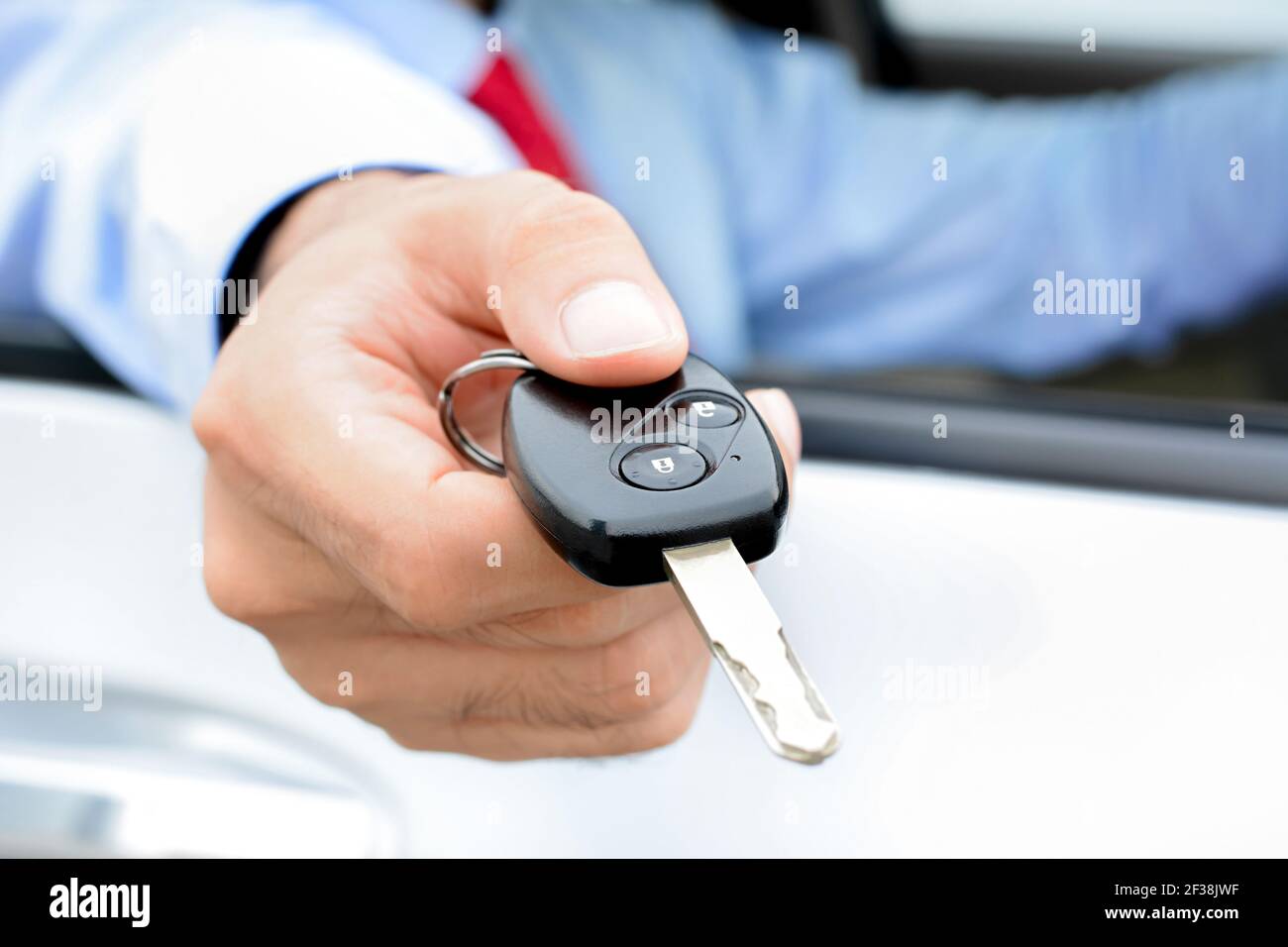 Hand giving a car key Stock Photo - Alamy