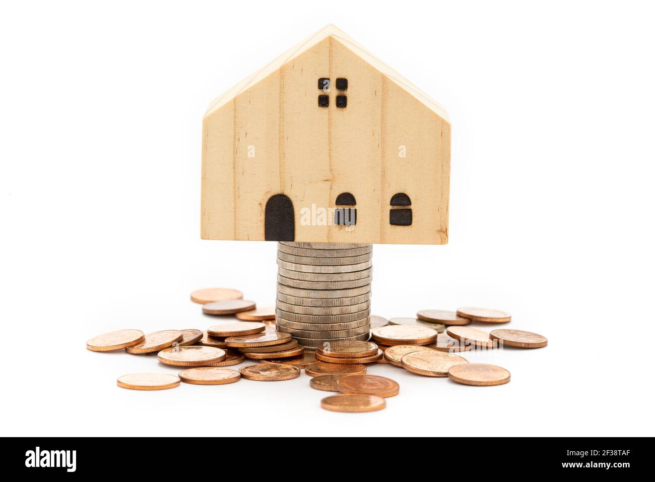 A model wooden house on stack of coins on white background Stock Photo ...