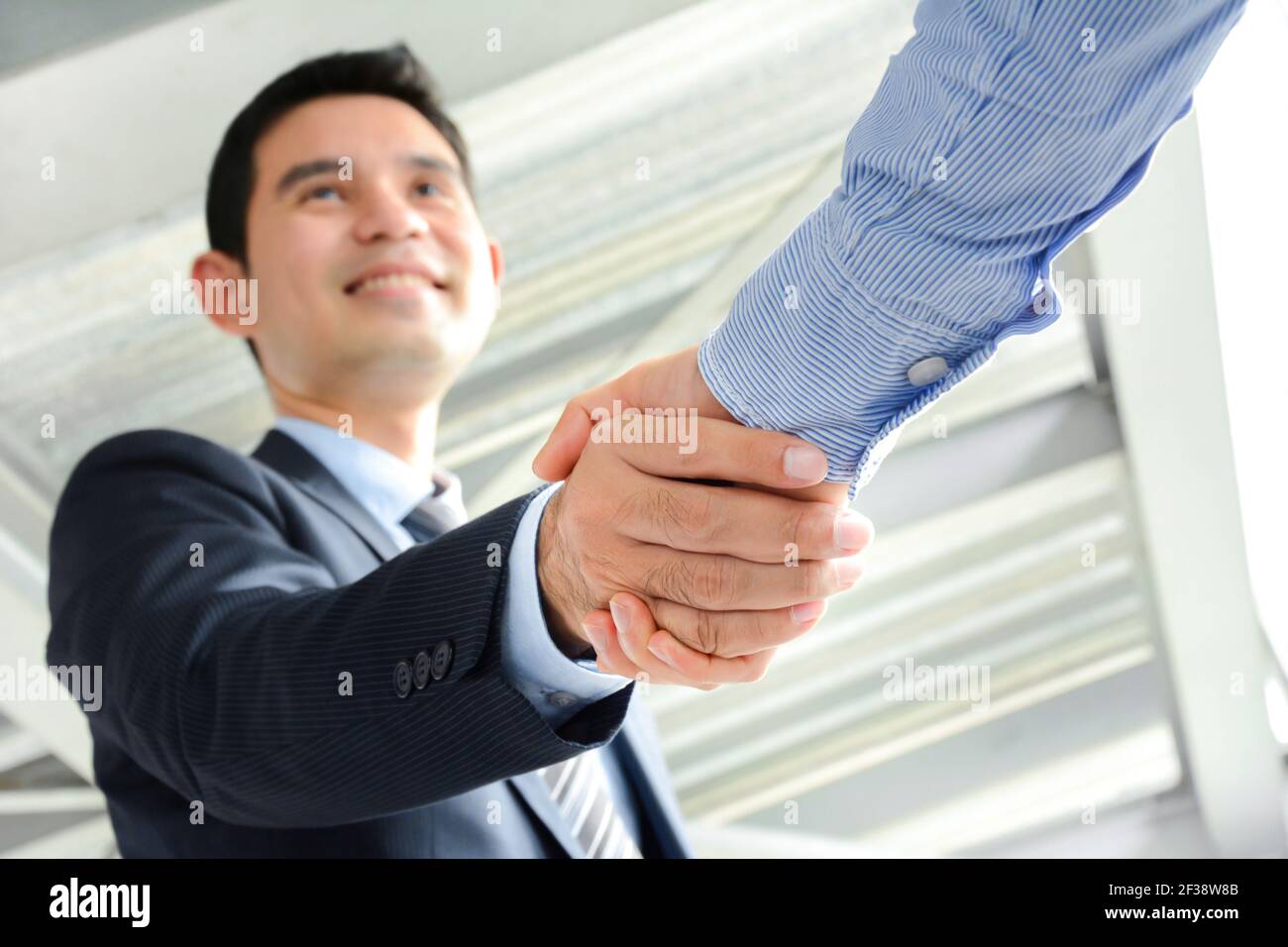 Businessmen making handshake with smiling face - greeting, dealing ...
