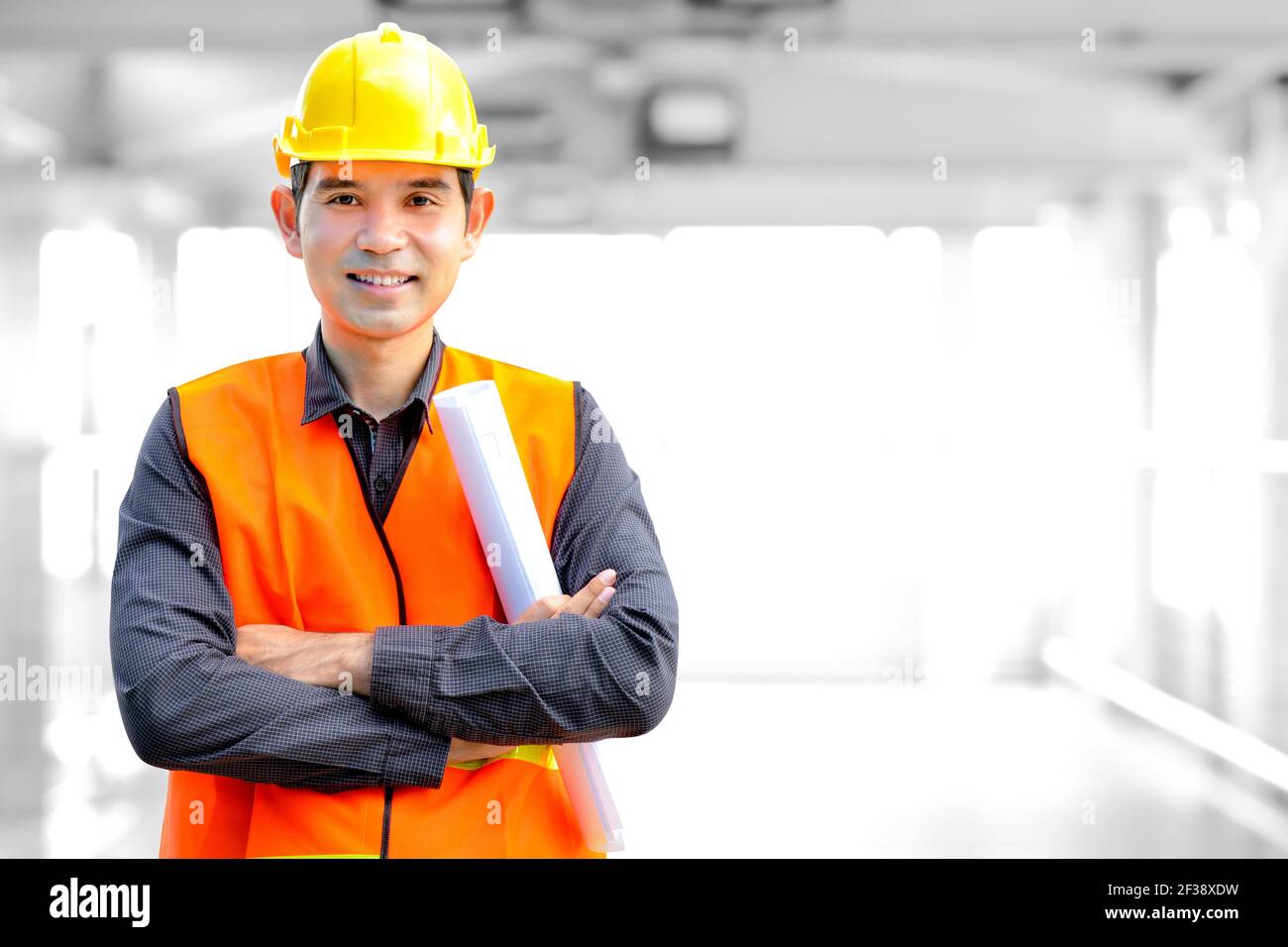 Asian architect or engineer wearing safety vest and hard hat (or helmet ...
