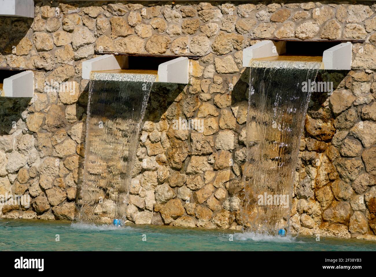Coral rock wall water fountain Stock Photo - Alamy