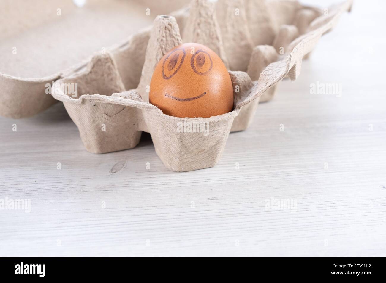 Smiling egg in a cardboard box Stock Photo - Alamy