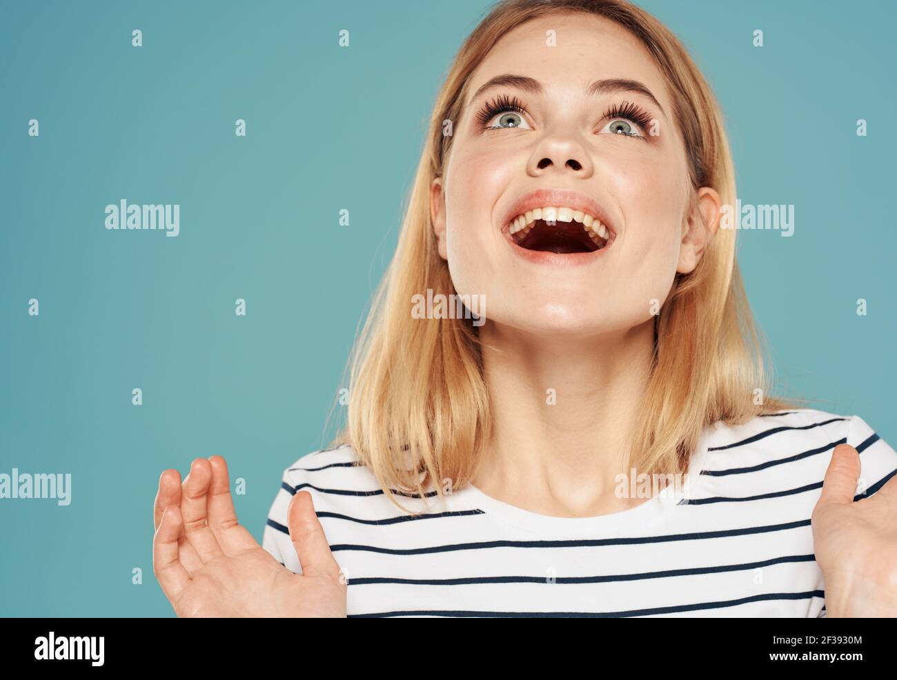 Portrait of happy woman close-up blue background beautiful face smile ...