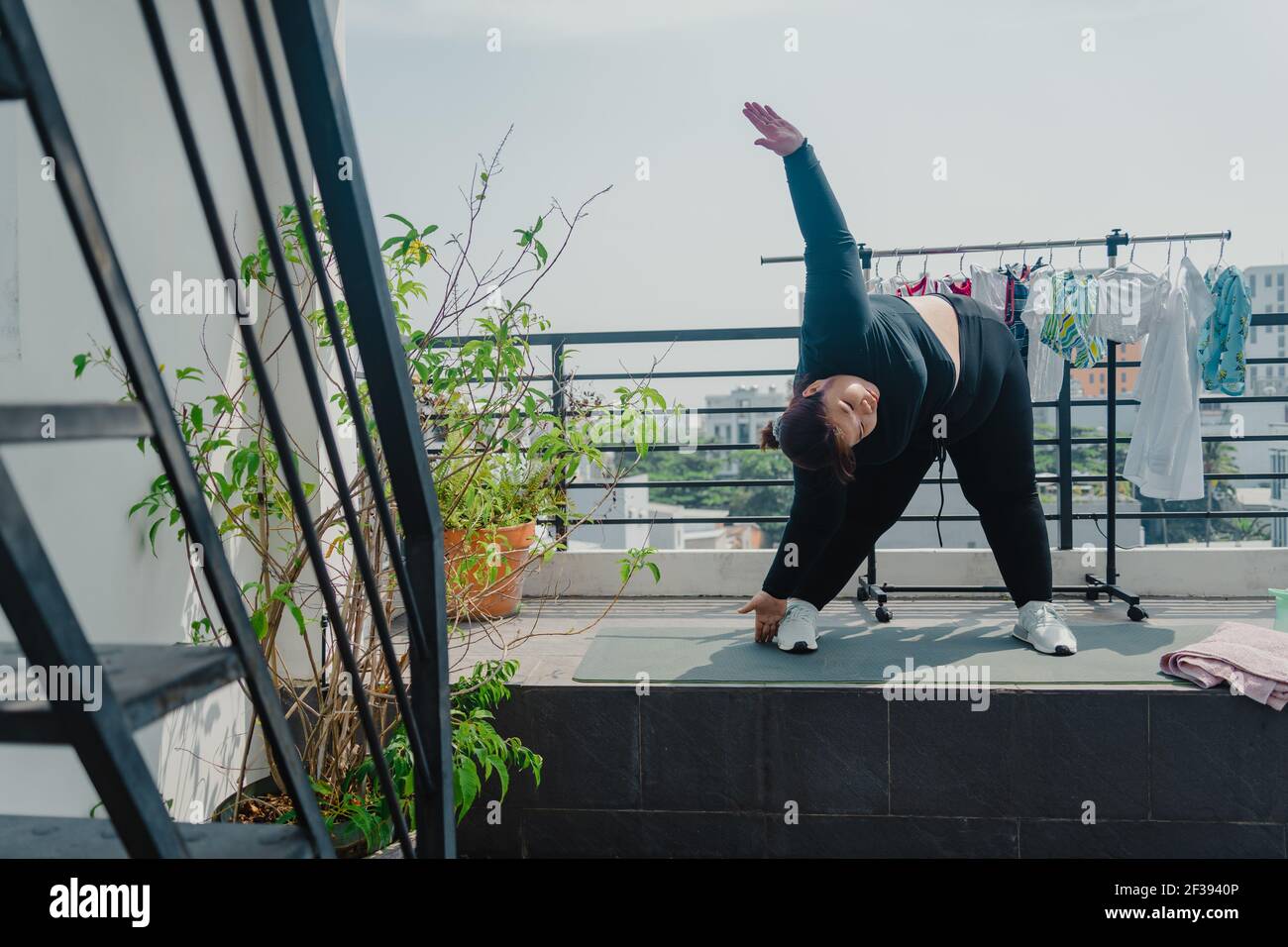 Health, fitness and sports concept. Plus size young asian woman doing ...