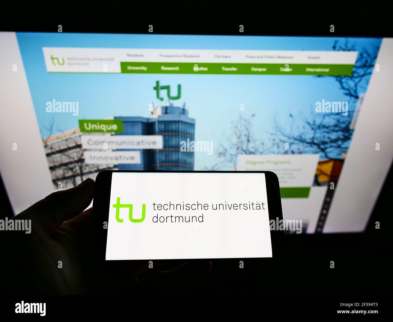 Person holding cellphone with logo of German Technical University of ...