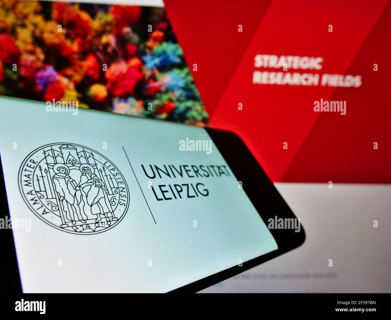 Cellphone with logo of German university Universität Leipzig on screen ...