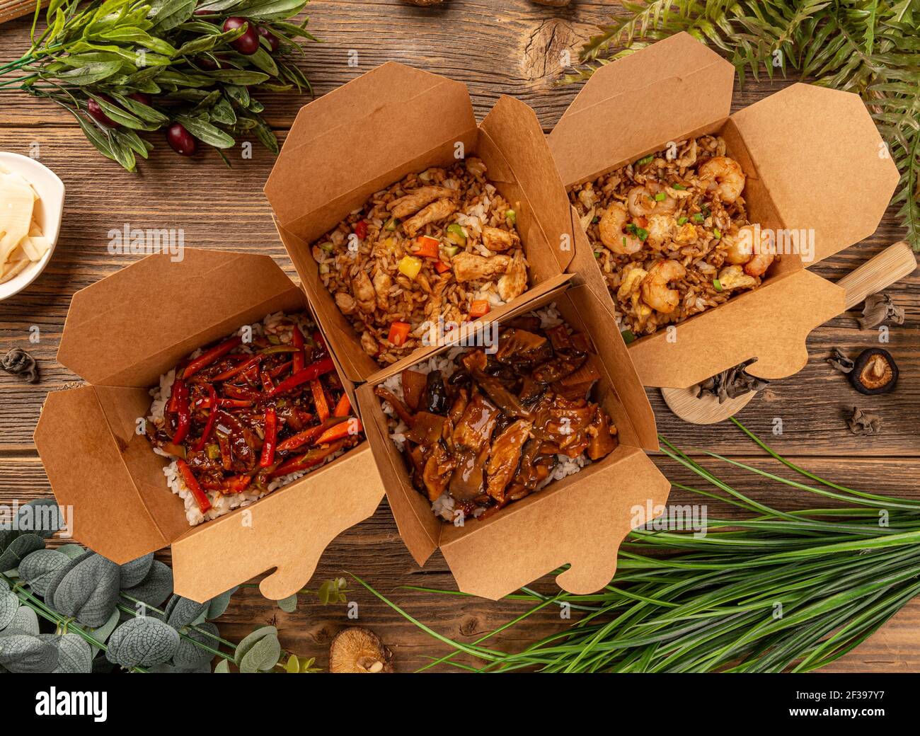 Chinese restaurant take-out box with various food on wooden background ...