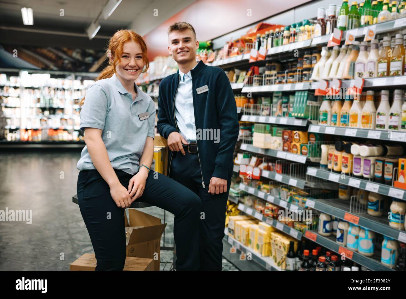 Portrait of two grocery store assistants. Male and female employees ...