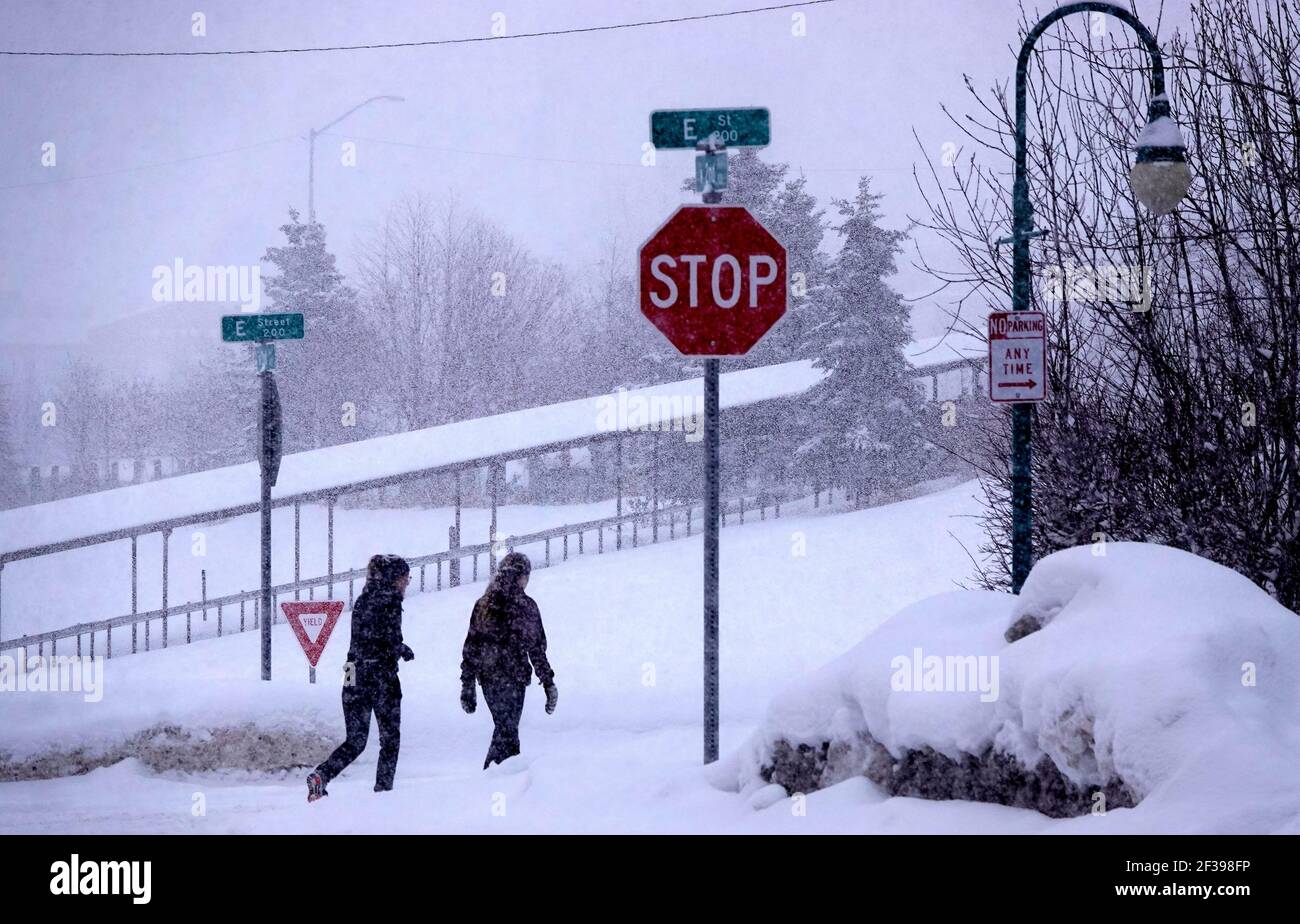 Anchorage, USA. 15th Mar, 2021. People walk in snow in Anchorage ...