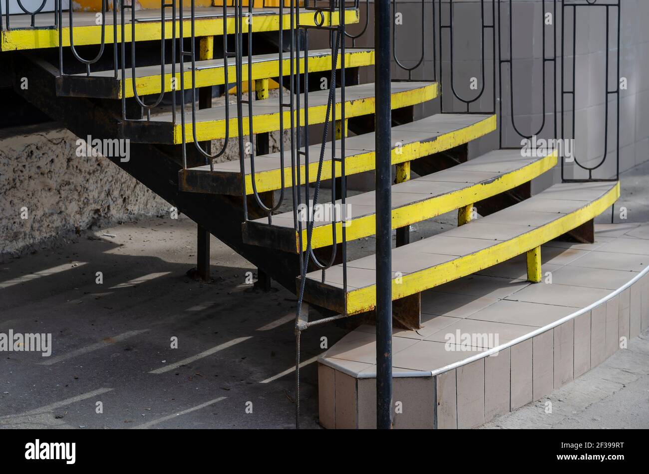Black and yellow steps with a railing. Entrance to the building ...