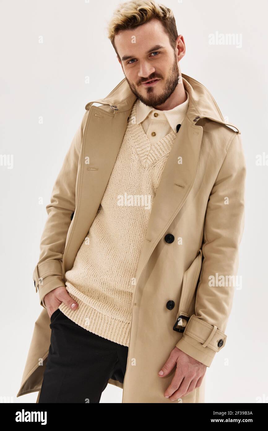 emotional man in beige coat autumn style fashion studio model Stock ...